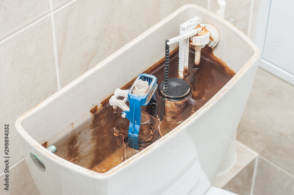 full toilet storage tank. Open mechanism. Float valve. Scale on the ...