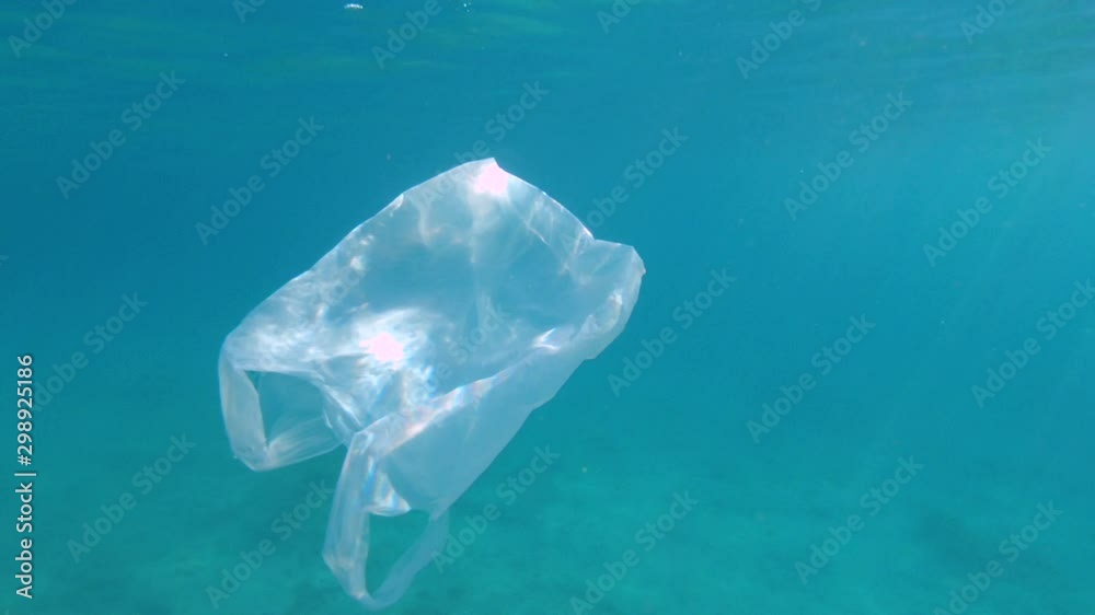 Underwater shoot of a discarded plastic bag floating below sea level ...