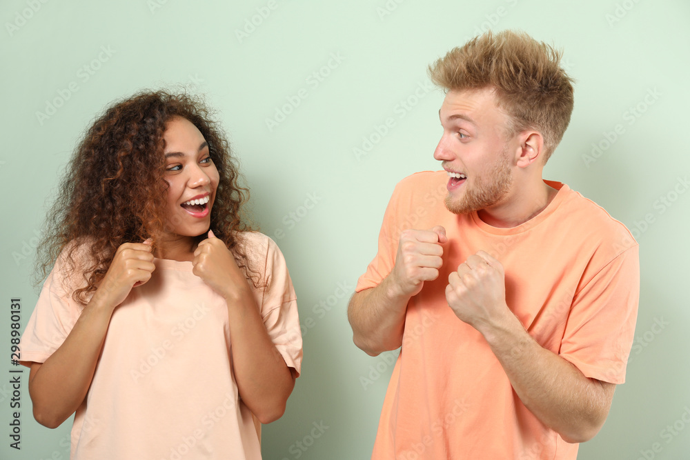 Portrait of surprised couple on color background Stock Photo | Adobe Stock