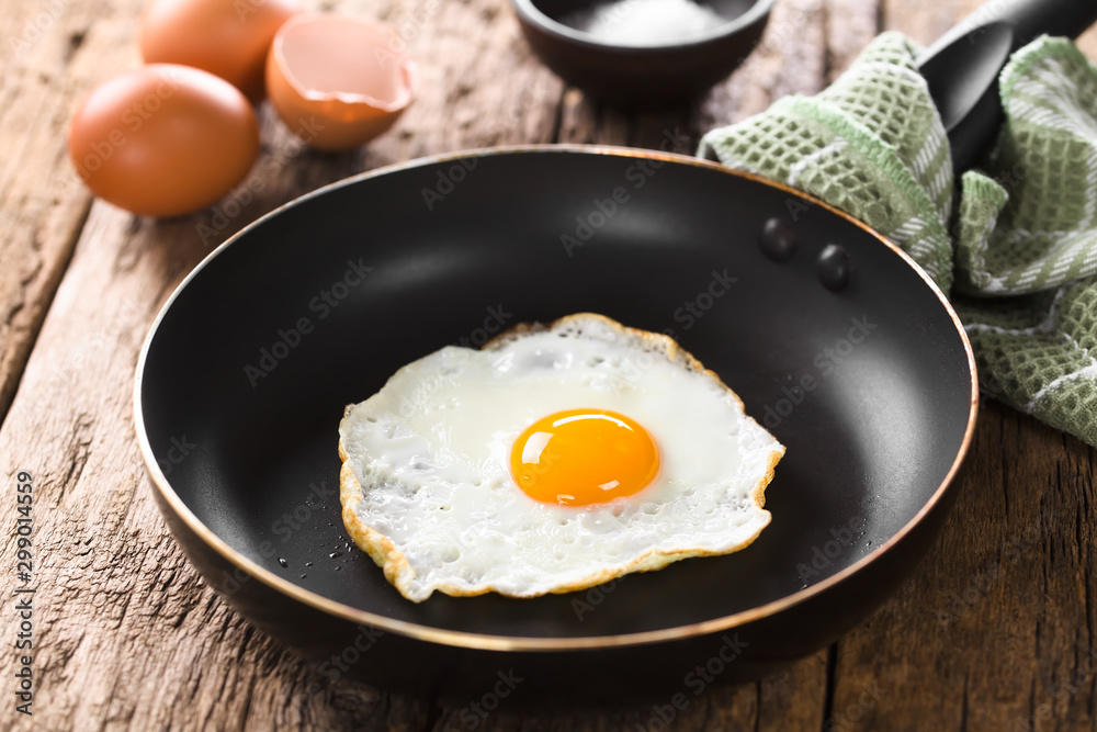 One fresh fried egg sunny side up in skillet (Selective Focus, Focus on ...