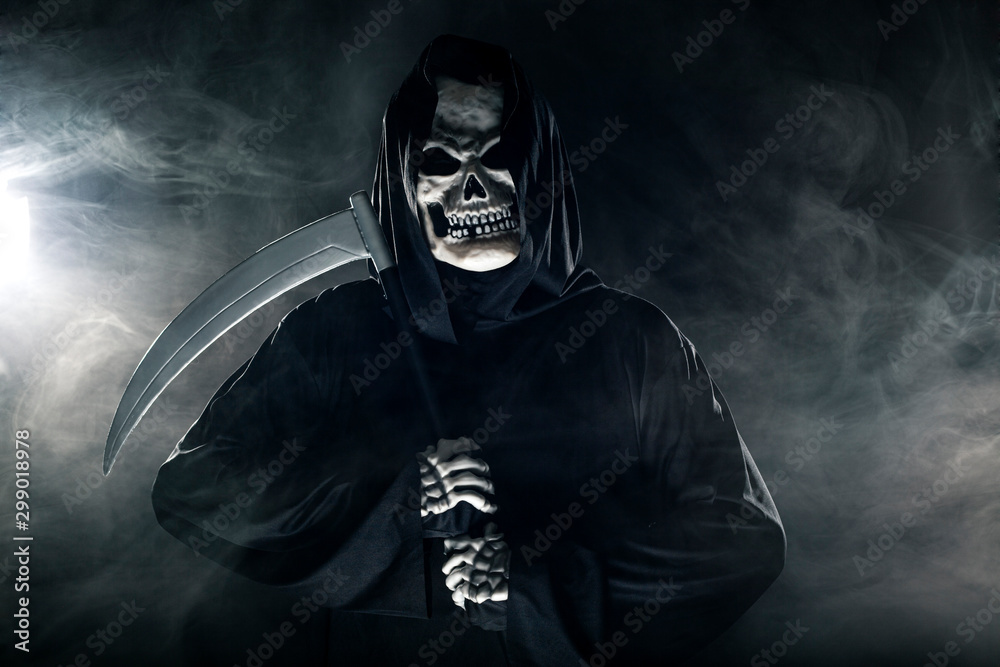 Scary looking grim reaper ghost wielding a scythe or sickle coming out ...