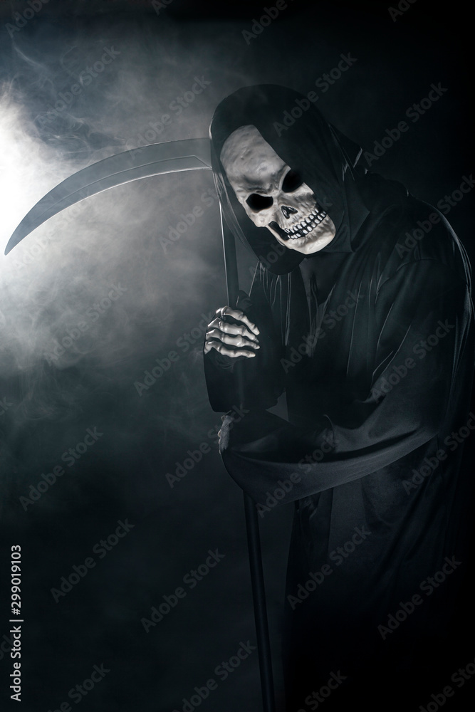 Scary looking grim reaper ghost wielding a scythe or sickle coming out ...