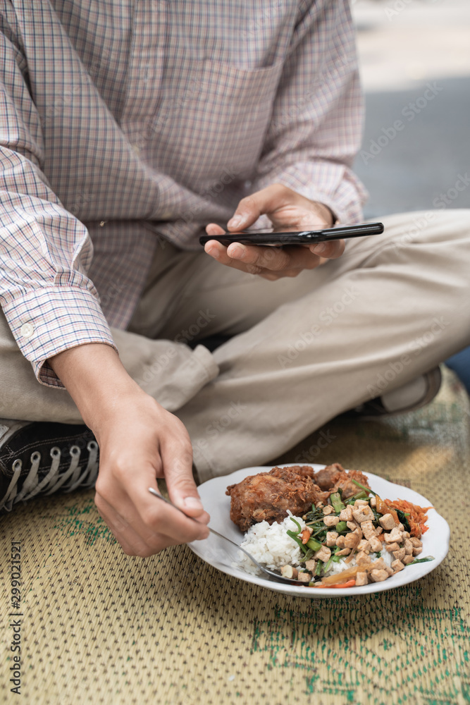 portrait of man eat traditional food of indonesia is nasi rames on the ...