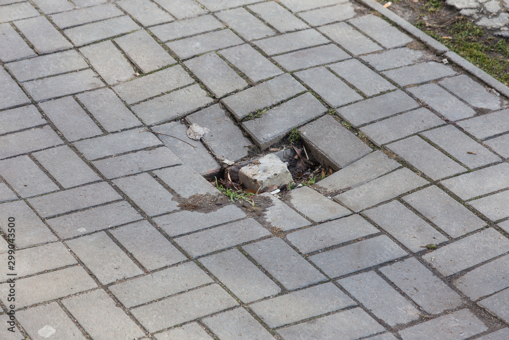 Damaged asphalt road with potholes, caused by freeze-thaw cycles in ...