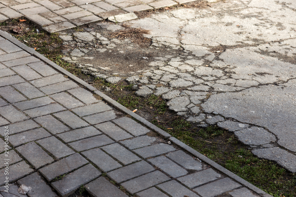 Damaged asphalt road with potholes, caused by freeze-thaw cycles in ...