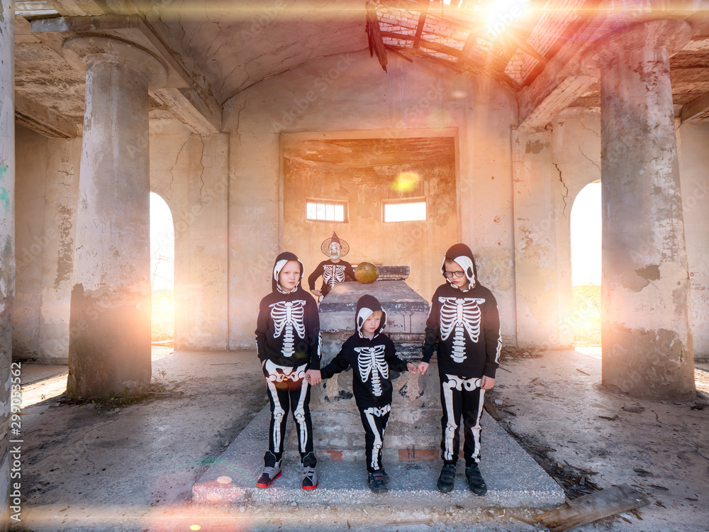 Children and their mother in carnival costumes celebrate Halloween in ...
