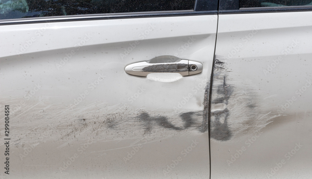 Car door handle and white car door have scratches from damaged by ...