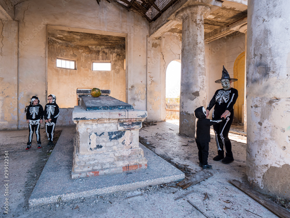 Children and their mother in carnival costumes celebrate Halloween in ...