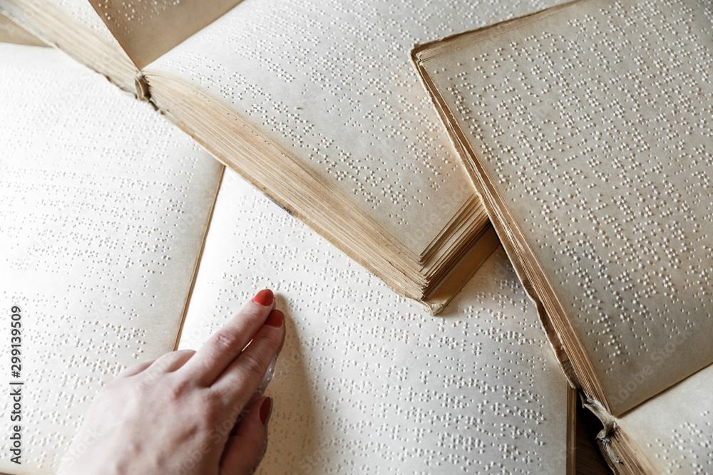 woman reading braille text on old book Stock Photo | Adobe Stock