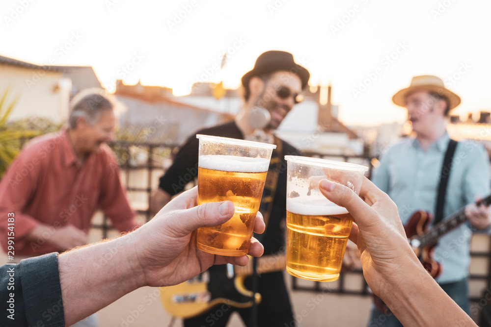 Friends making a toast over their friendship. Young people holding cups ...