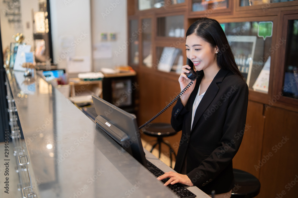 Welcome to the hotel,Happy young Asian woman hotel receptionist worker ...