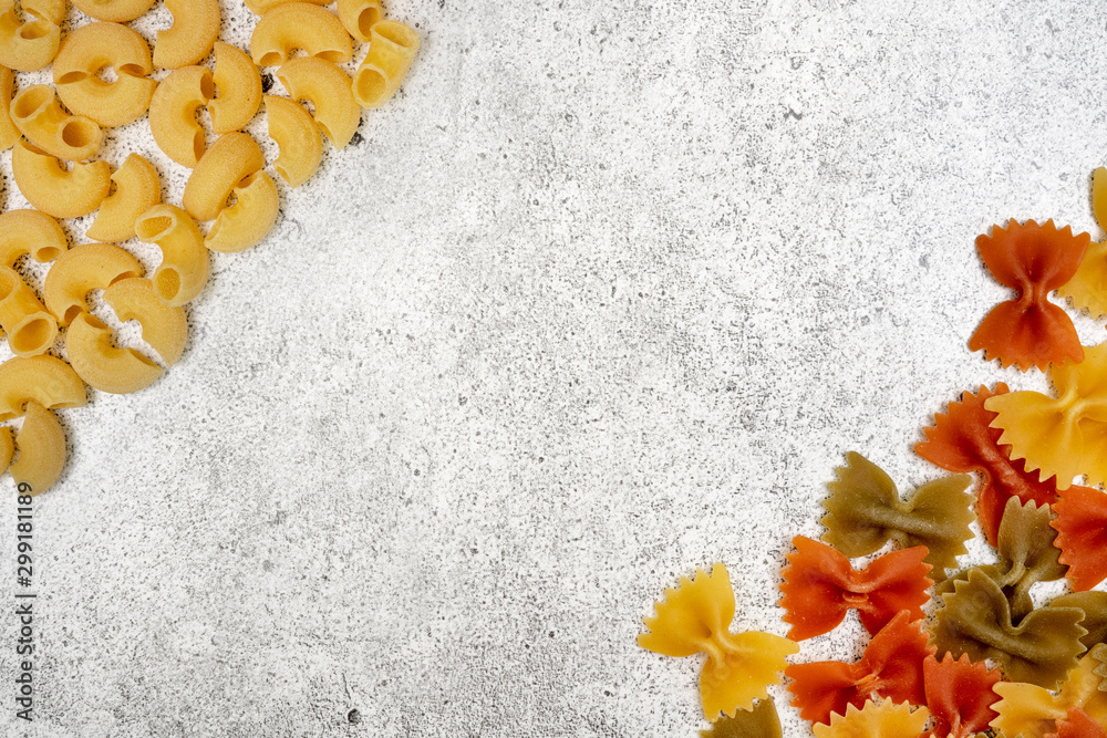 Types of uncooked pasta. Pasta chifferi and green, yellow and red ...