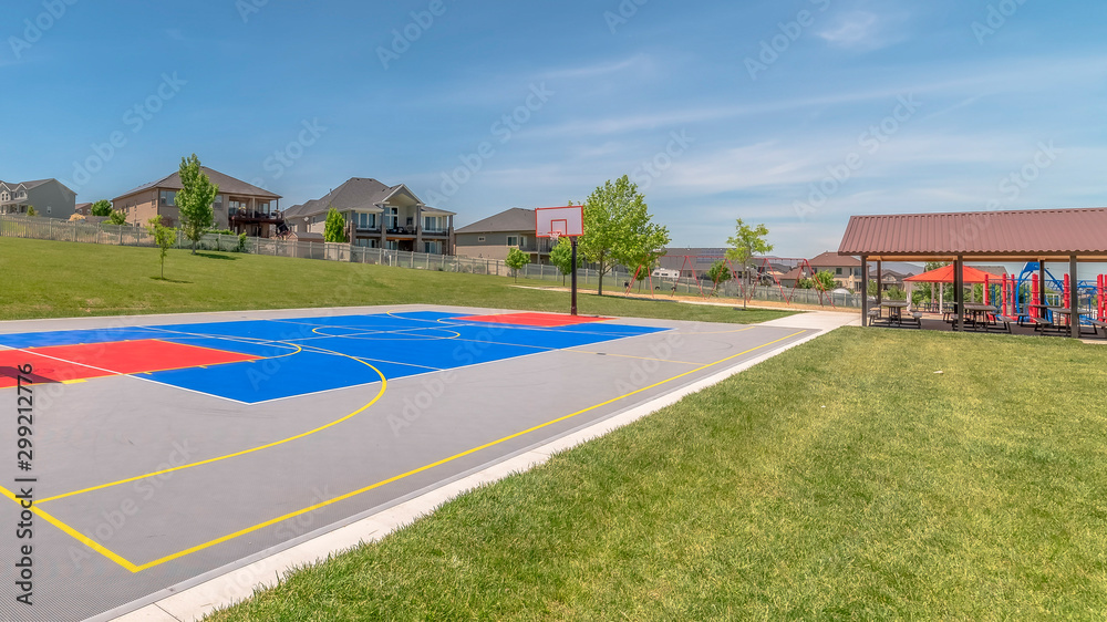 Panorama Basketball court pavilion and playground at a park under blue ...
