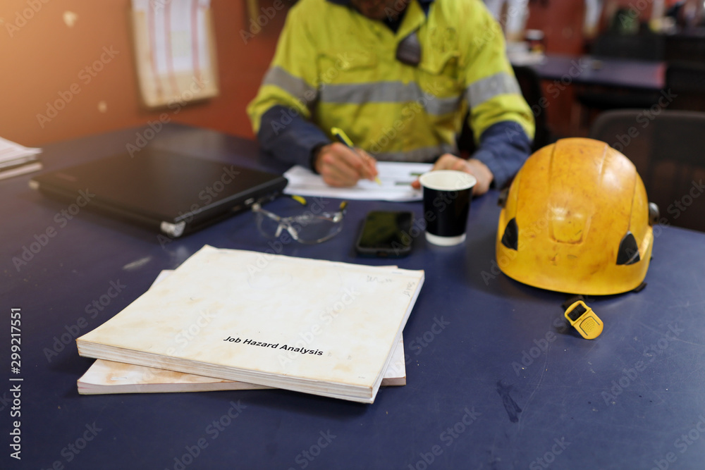 Defocused of miner seating on the chair written Job hazard analysis ...
