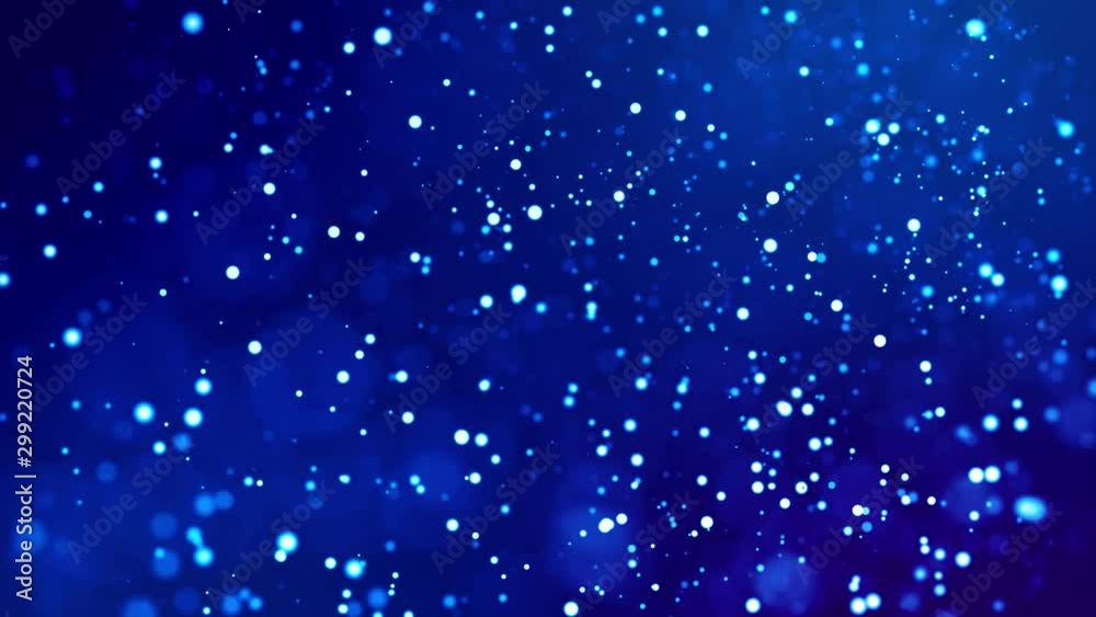 glitter blue magic particles fly and glow in viscous liquid with ...