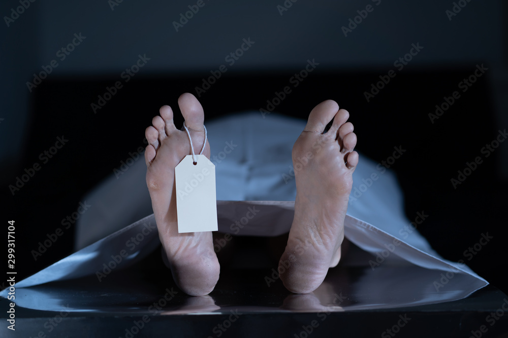 Cadaver on autopsy table at morgue, label tied to toe, close-up Stock ...