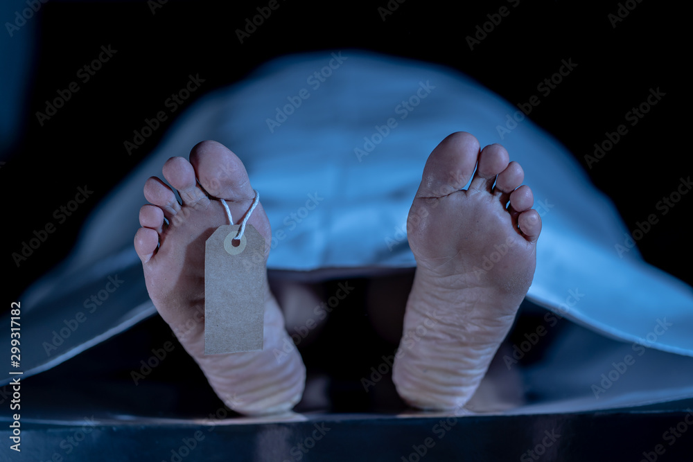 Cadaver on autopsy table at morgue, label tied to toe, close-up Stock ...