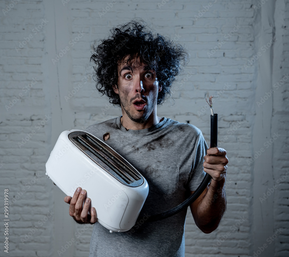 Funny man after suffering an electric shock fixing a toaster. Domestic ...