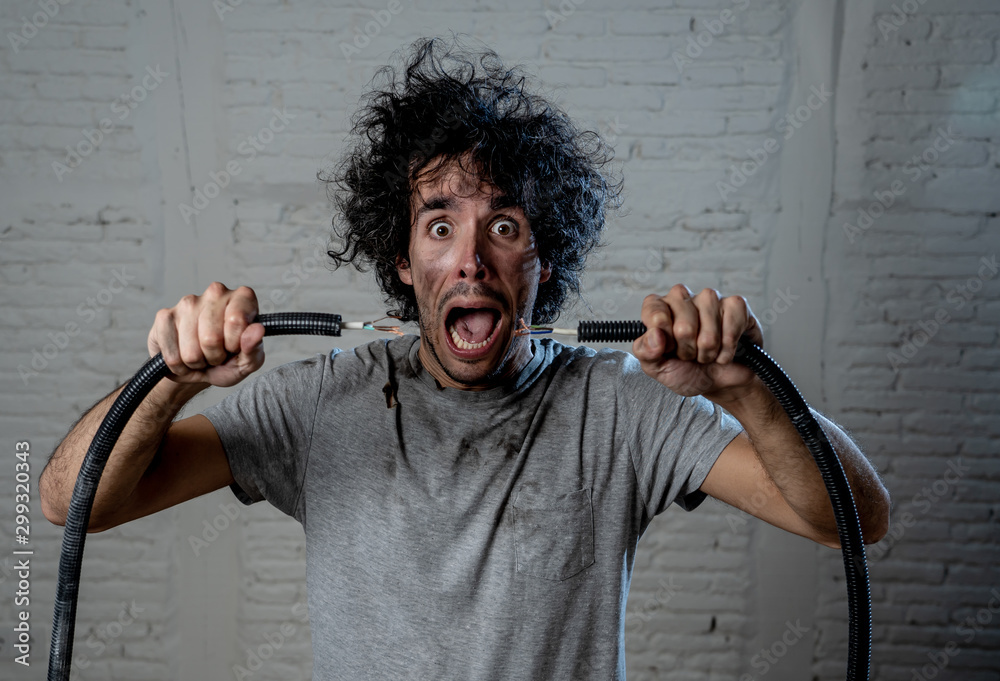 Foto de Funny image of man getting electric shock with funny face and ...