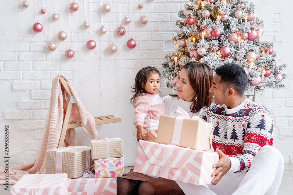 Little restless child climbs on boxes with gifts on the background of ...