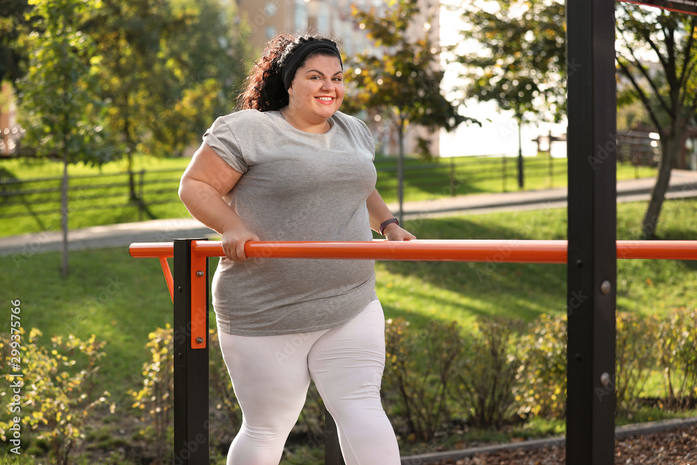 Beautiful overweight woman training on sports ground Stock Photo ...