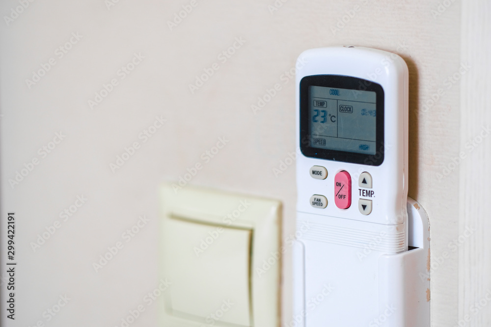 image of the remote control from the air conditioner in the holder on ...