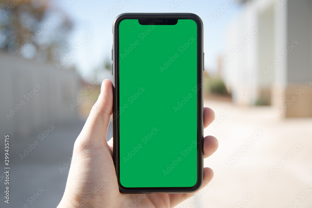 iPhone XS w/Green Screen in Hand Stock Photo | Adobe Stock