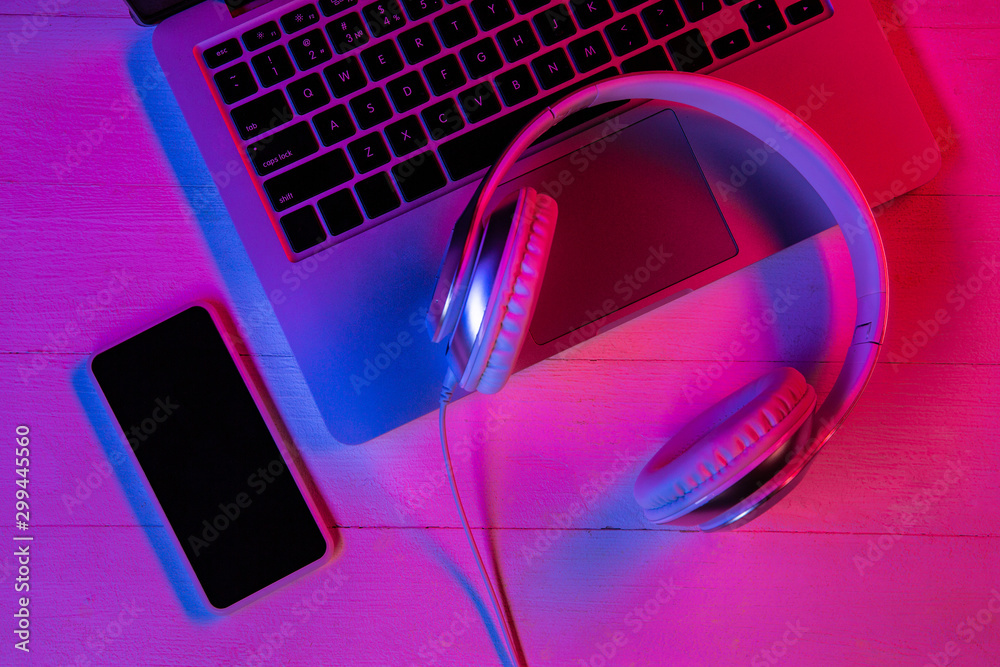 Top view of set of gadgets in purple neon light and pink background ...