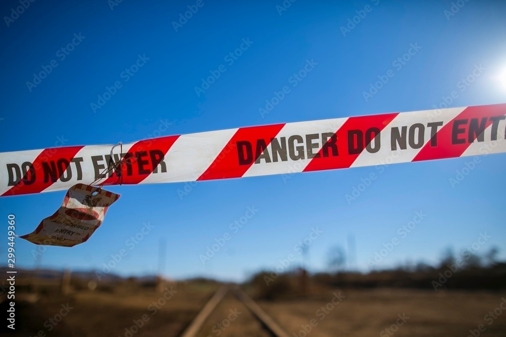 Danger red and white tape barricade exclusion zone area with written ...