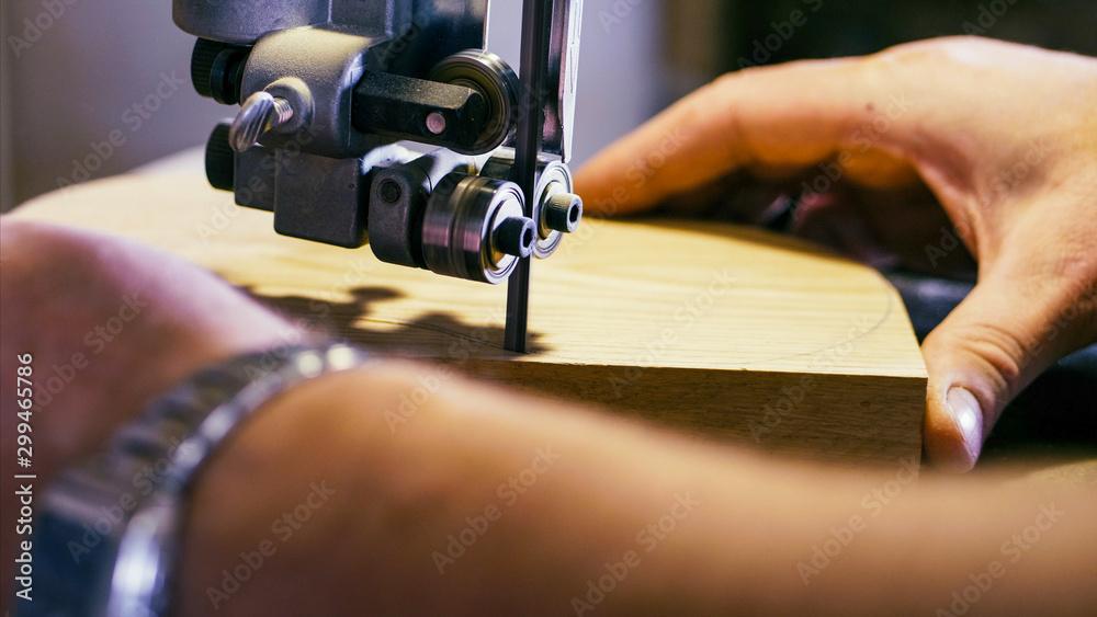 Closeup hands of male carpenter working on milling machine with wooden ...
