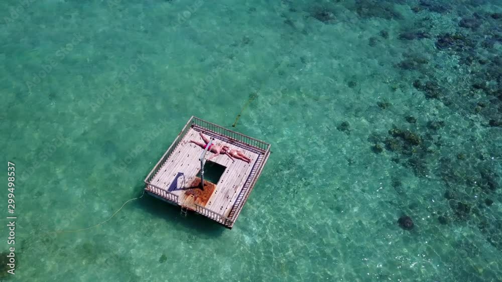 Sweet Couple Sunbathing in the Small Raft Floating in the Middle of the ...