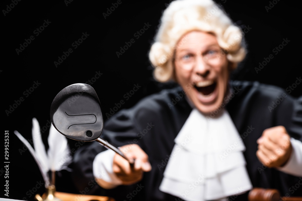 selective focus of angry judge in judicial robe and wig holding golf ...