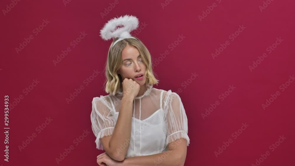 Exhausted angel woman in carnival costume wiping sweat from her ...