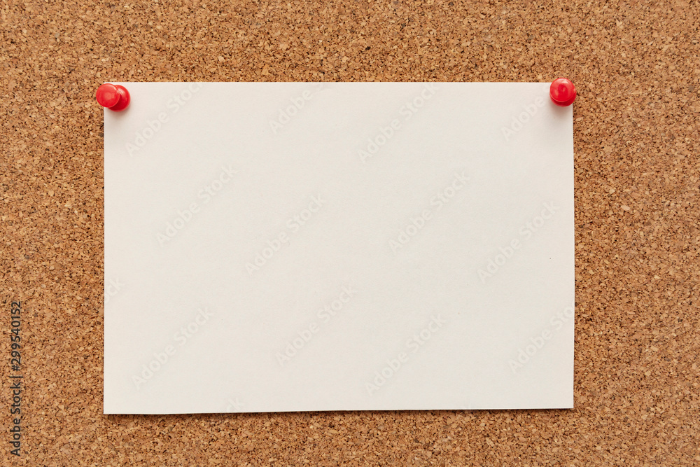 Note paper swith push pins on cork board. Empty paper pages for notes ...