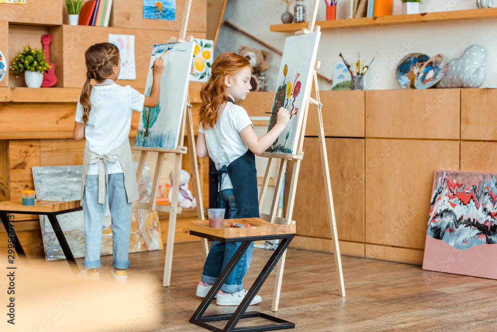 selective focus of cute kids standing and painting in art school Stock ...