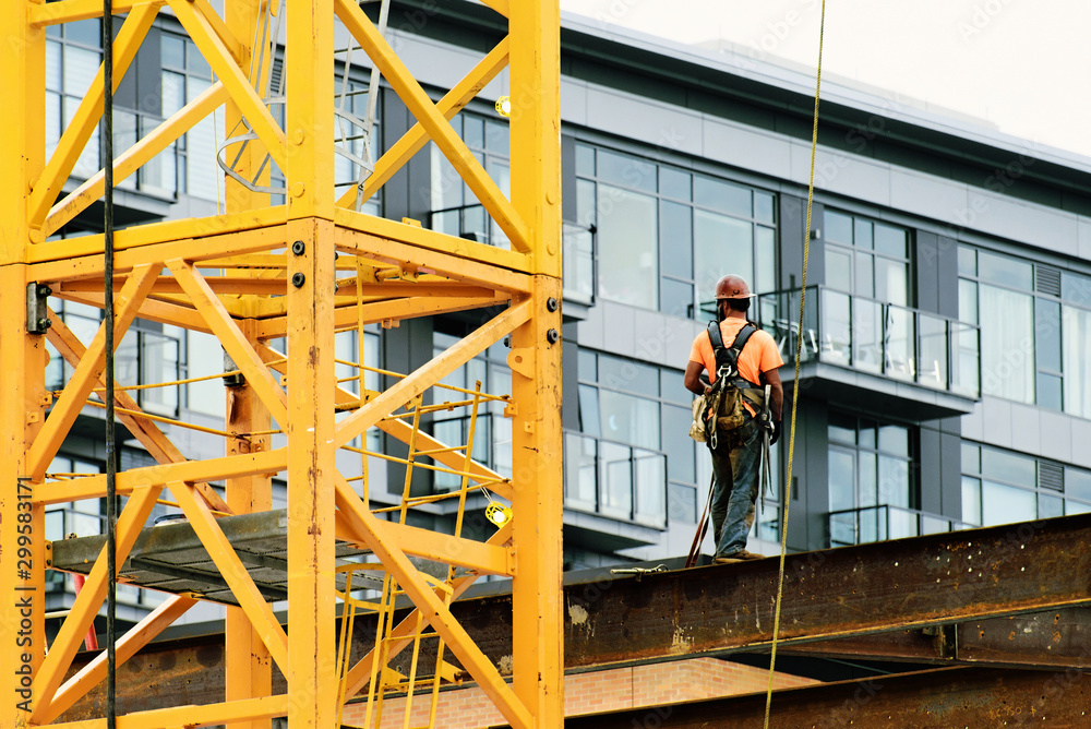 Construction worker wearing safety harnesses and safety line working ...