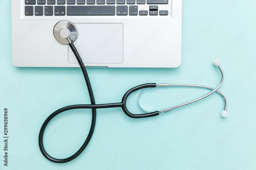 Stethoscope keyboard laptop computer isolated on blue background ...