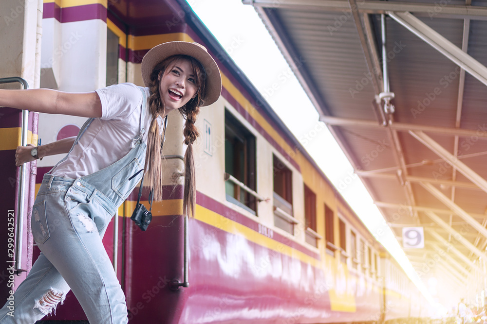 Travelers young woman getting off the train at train station with copy ...