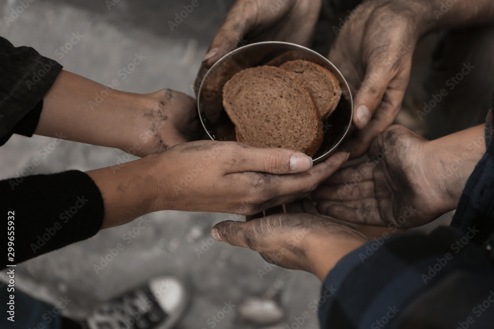 Poor homeless people with pieces of bread outdoors, closeup Stock Photo ...