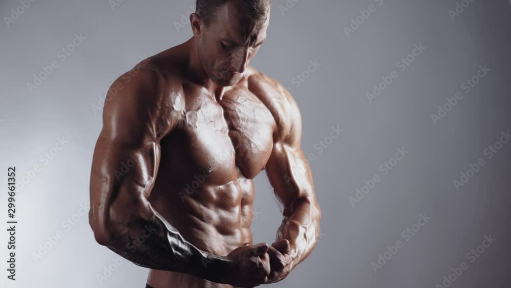 Handsome shirtless athletic man posing on a gray background. Athletic ...