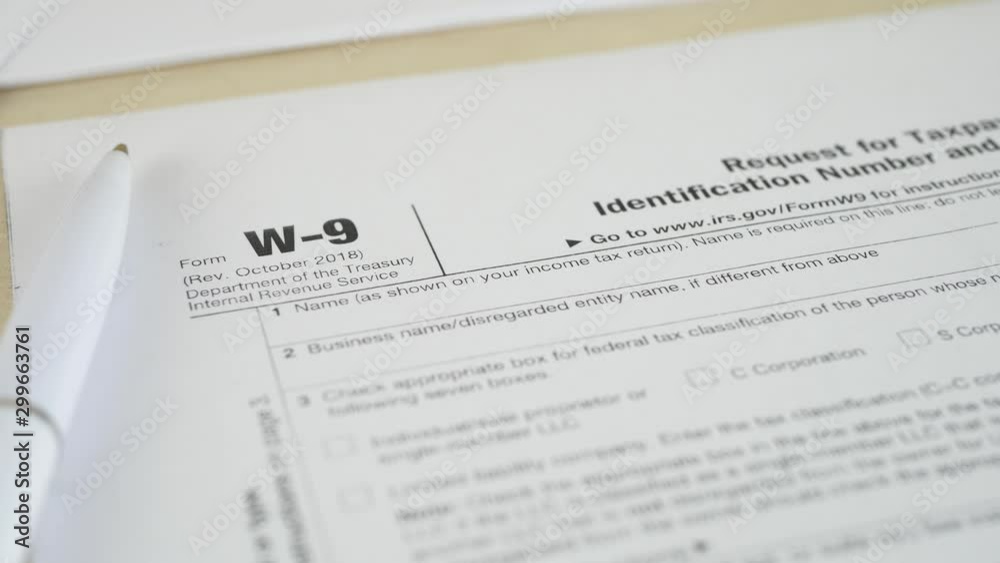 IRS W-9 Tax Form with pen. Wage and tax statement concept. American ...