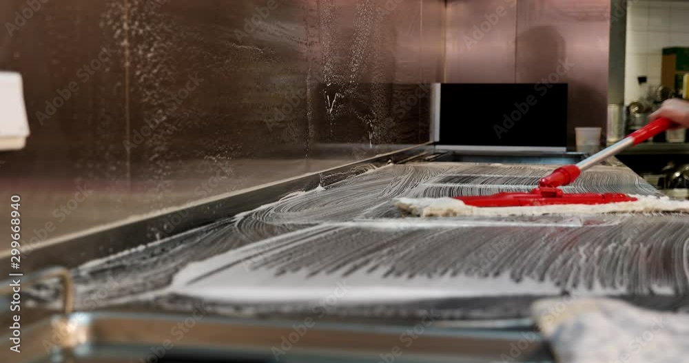 Video „Employee cleaning and wipe out kitchen's cooking station on ...