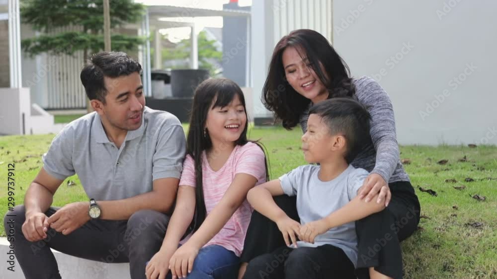 beautiful happy asian family in front of their house having fun and ...