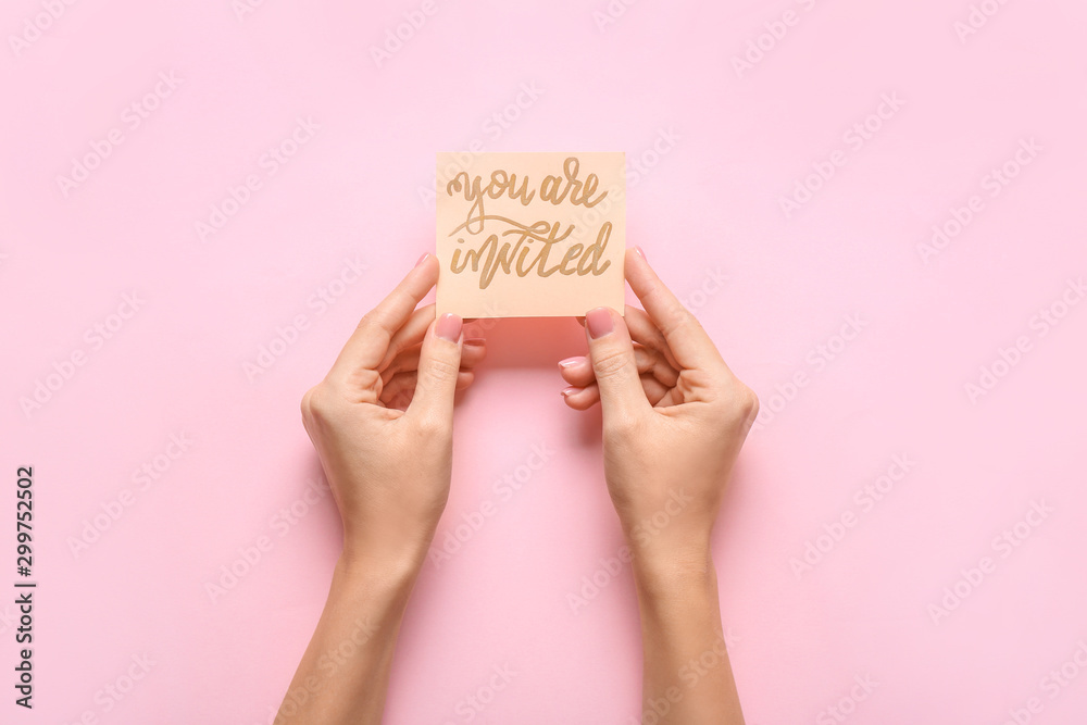 Female hands with invitation on color background Stock Photo | Adobe Stock