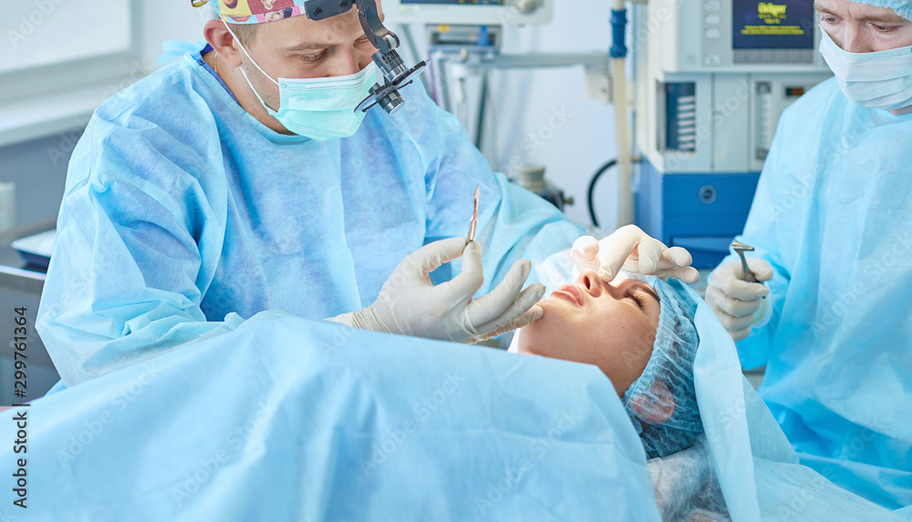 Several doctors surrounding patient on operation table during their ...