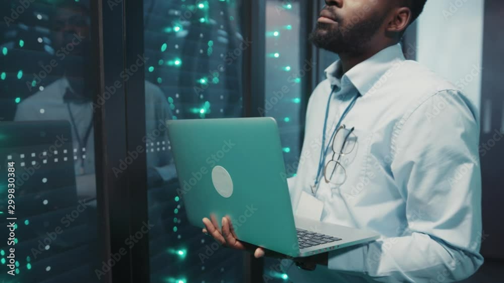 Data center. Computer security. Experienced black administrator using ...