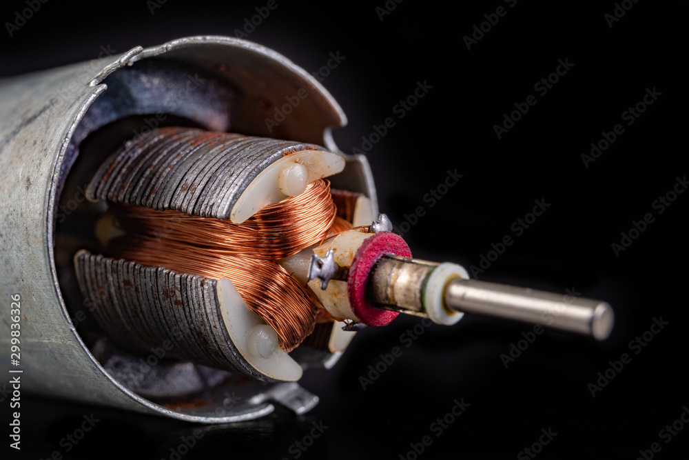 The rotor of an electric motor used for toys. Winding of a small ...