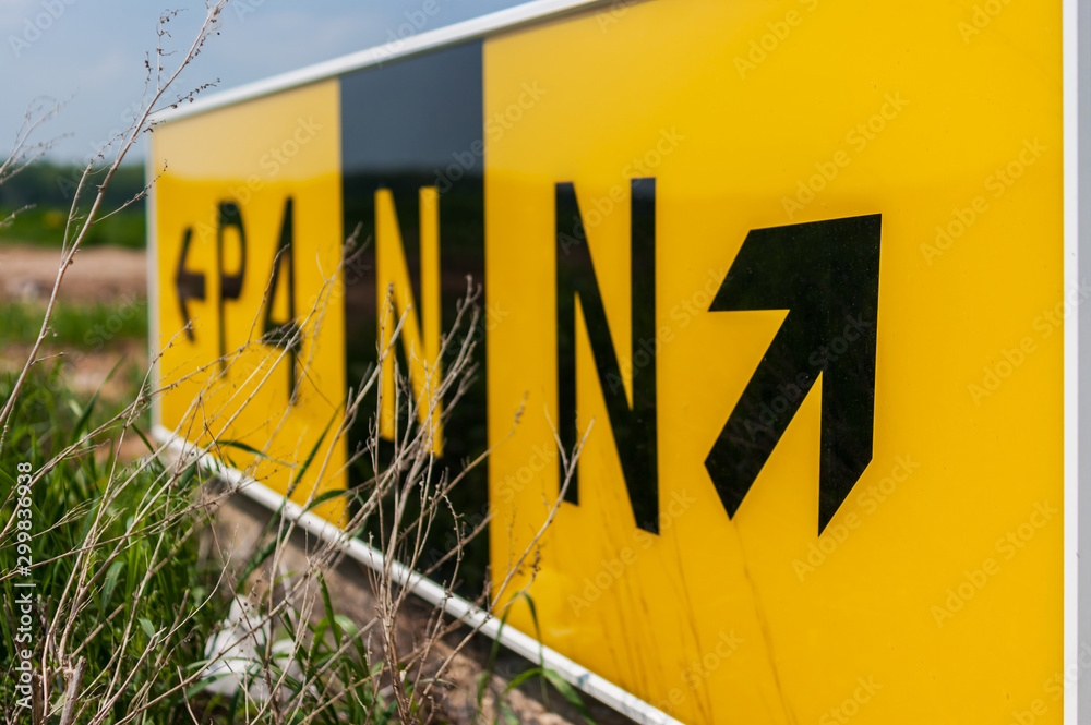 Airport taxiway sign. Directional sign markings by the runway in a ...
