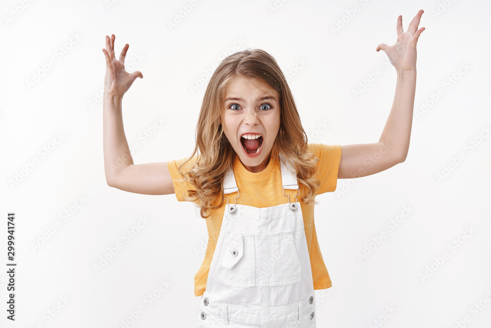 Angry little girl losing temper arging, raise hands full dismay and ...