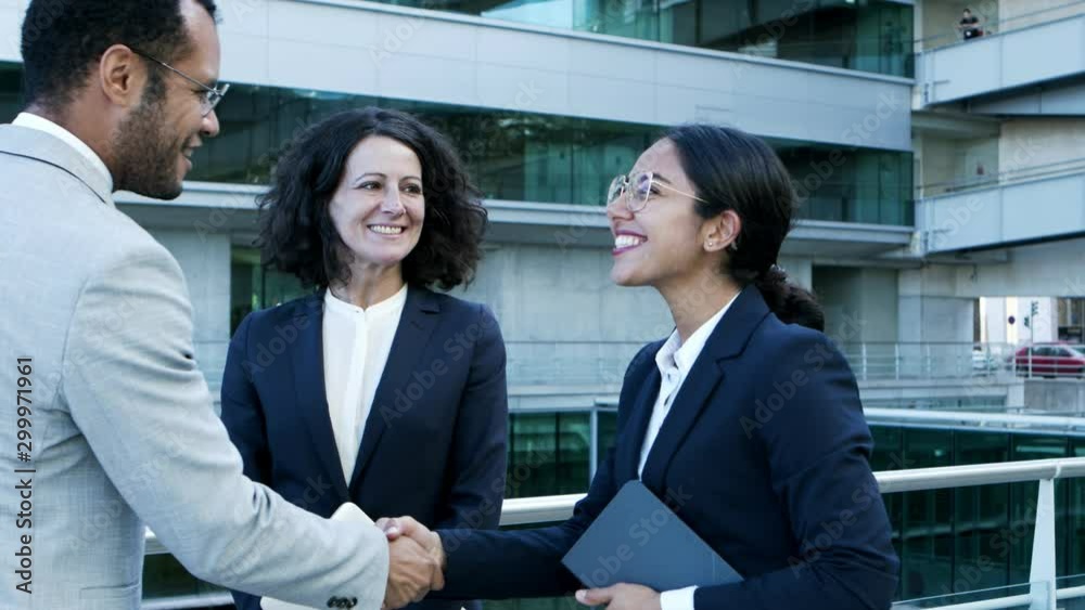 Happy business people greeting each other. Group of professional ...